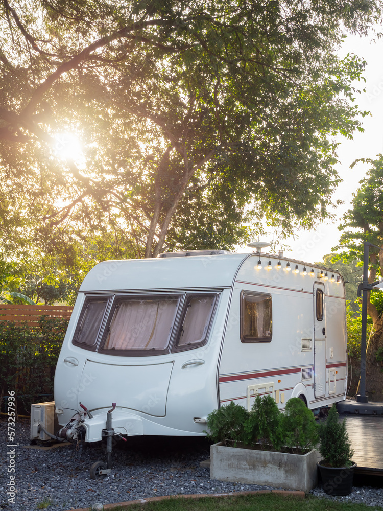 Caravan car park in the garden decoration with festive wire light bulbs ...