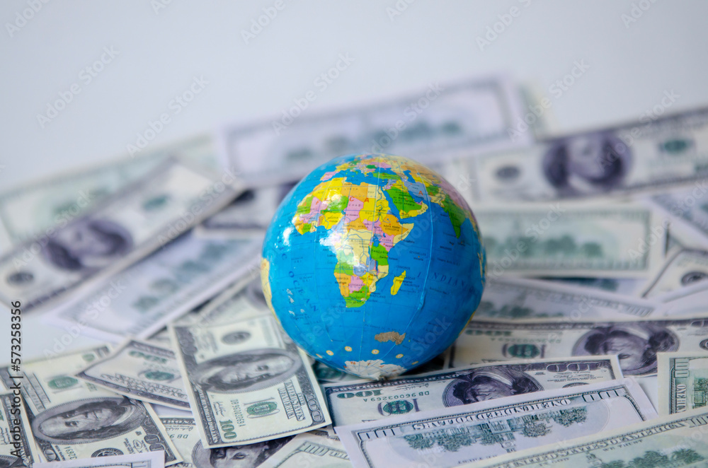 Globe over many American dollar banknotes.Economy background with ...