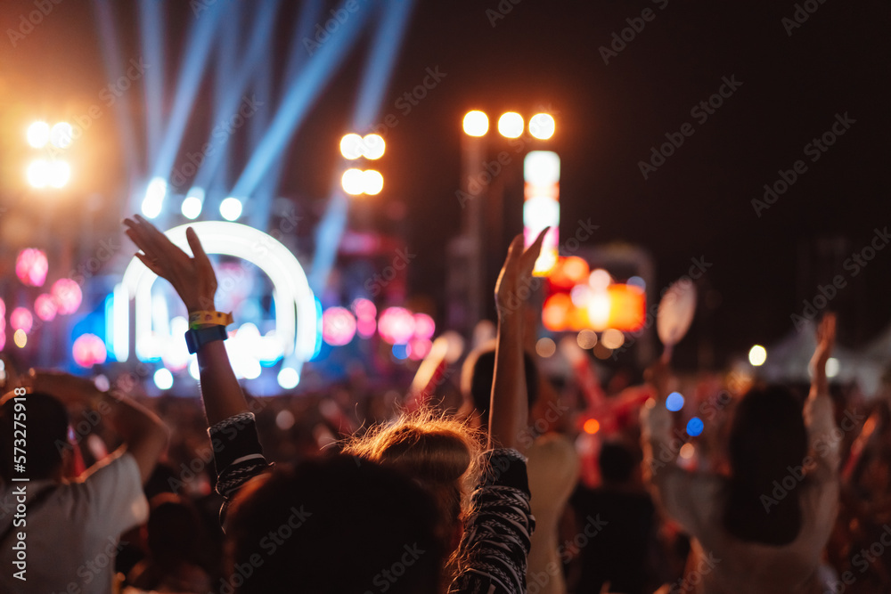 Crowd of hands up concert stage lights and people fan audience ...