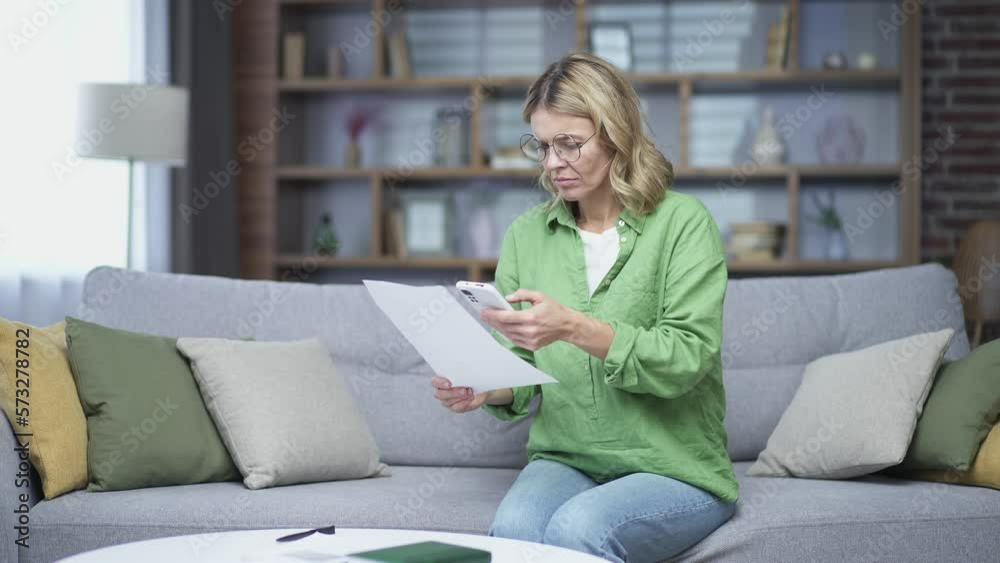 Confused mature woman can't deal with documents doing home accounting ...