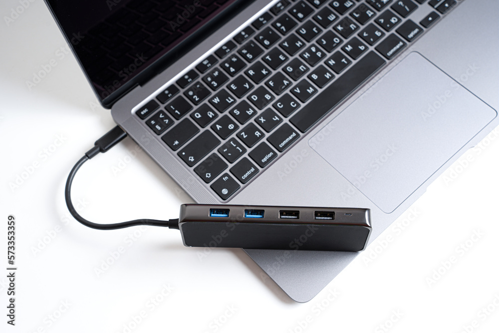 Top view of a multiport usb expansion adapter placed on a laptop ...