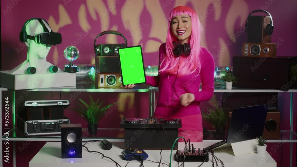Artist holding vertically green screen chroma key tablet computer with ...