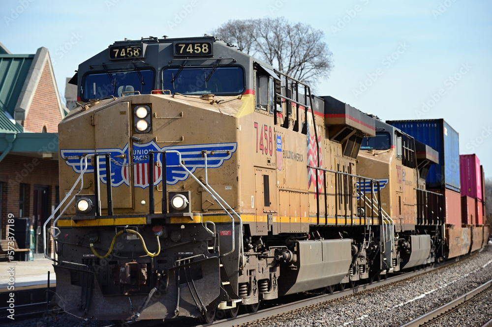 Two locomotives lead an intermodal freight train through the western ...