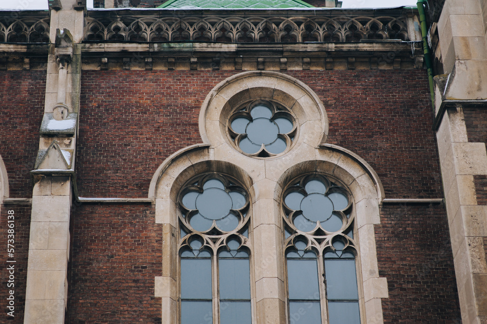 Round window with stained glass on facade of the building. Baroque and ...