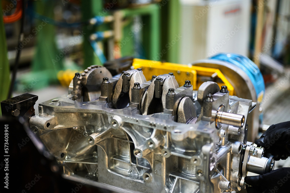 Cylinder block complete with crankshaft. Assembly line of internal ...