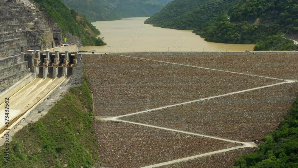 Camera flies backwards revealing the flood gates of the Hidroituango ...