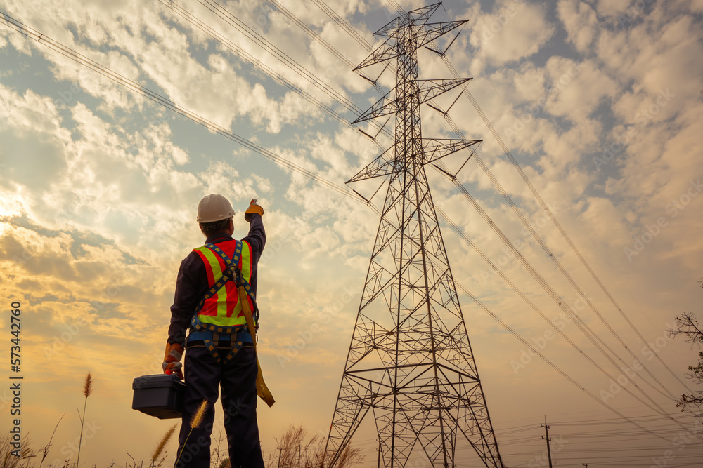 Asian electrical engineer wearing safety gear working high voltage ...