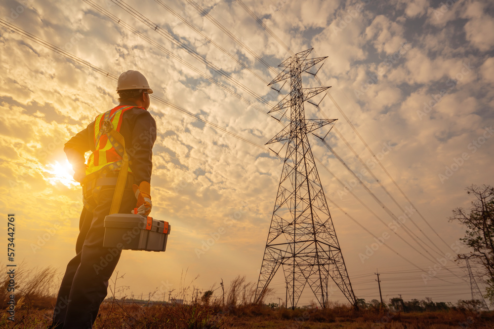 Asian electrical engineer wearing safety gear working high voltage ...