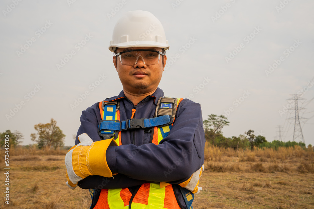 Fotka „Asian electrical engineer wearing safety gear working high ...
