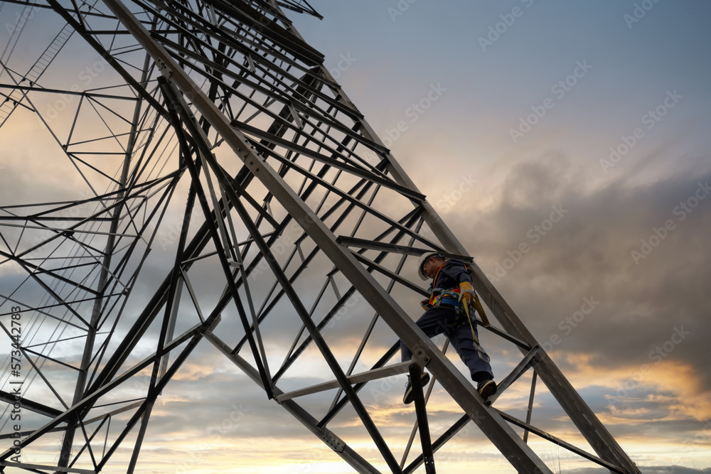 Asian electrical engineer wearing safety gear working high voltage ...
