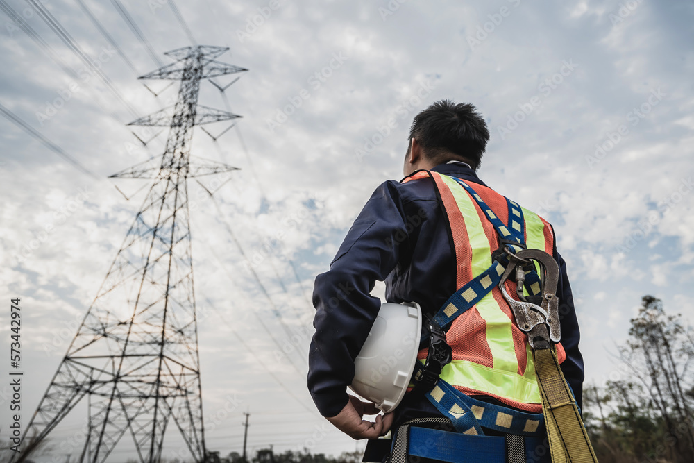 Asian electrical engineer wearing safety gear working high voltage ...
