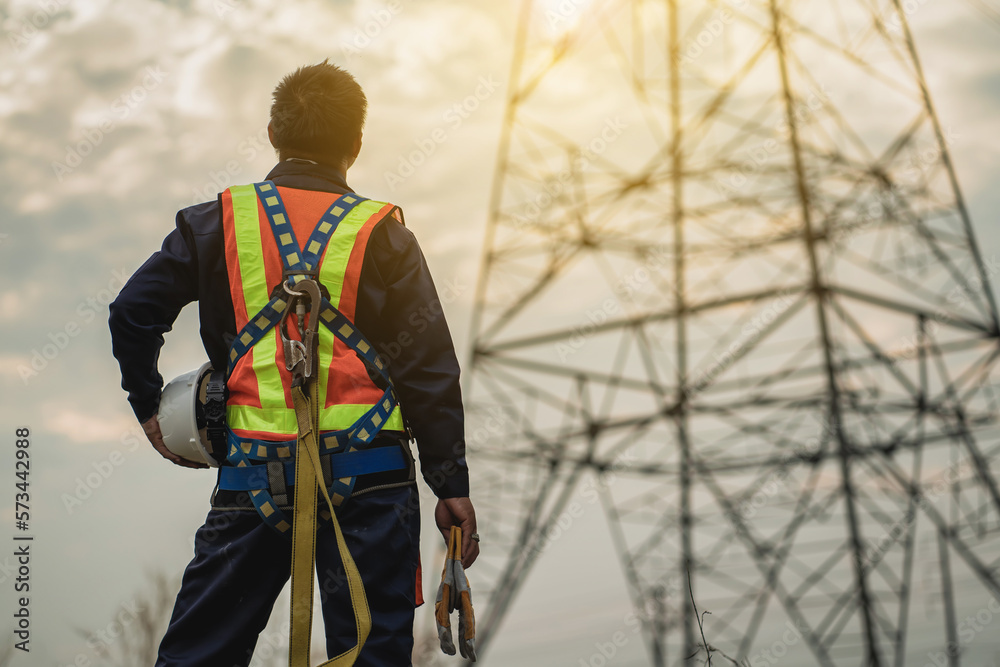 Asian electrical engineer wearing safety gear working high voltage ...