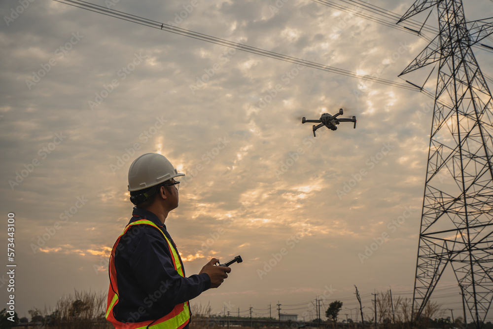 Asian electrical engineer wearing safety gear working high voltage ...