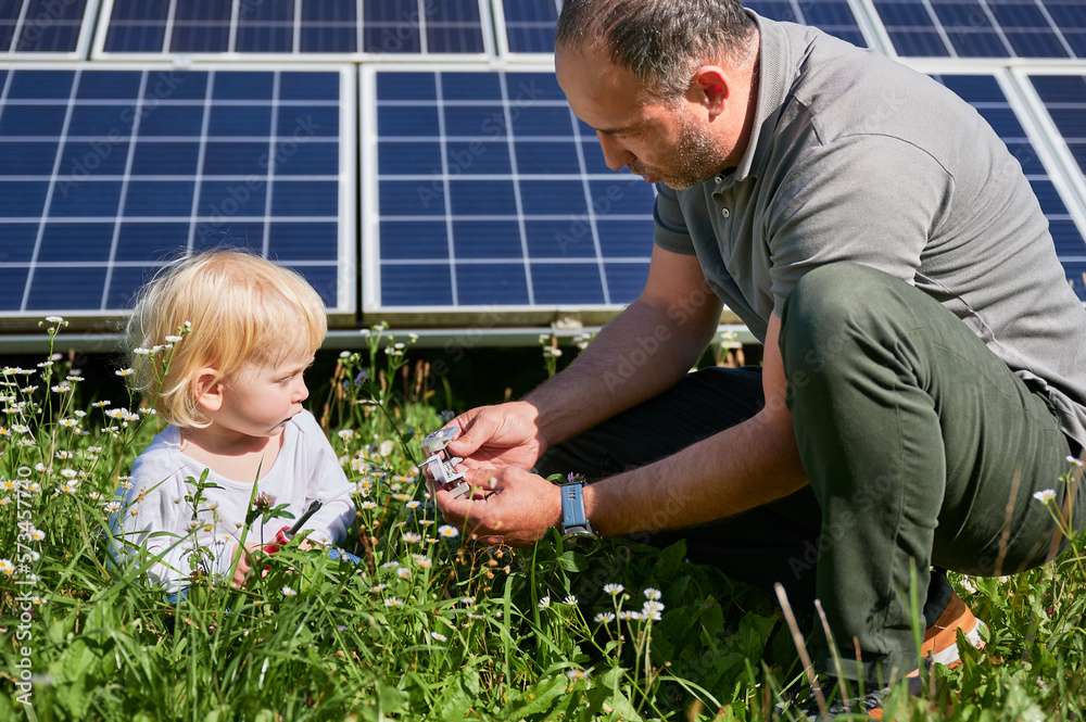 Father showing to his little son how to use tools in background of ...