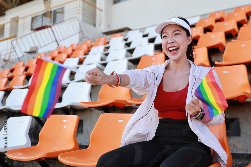 Happy and excited young female asian transgender LGBT sport fan ...