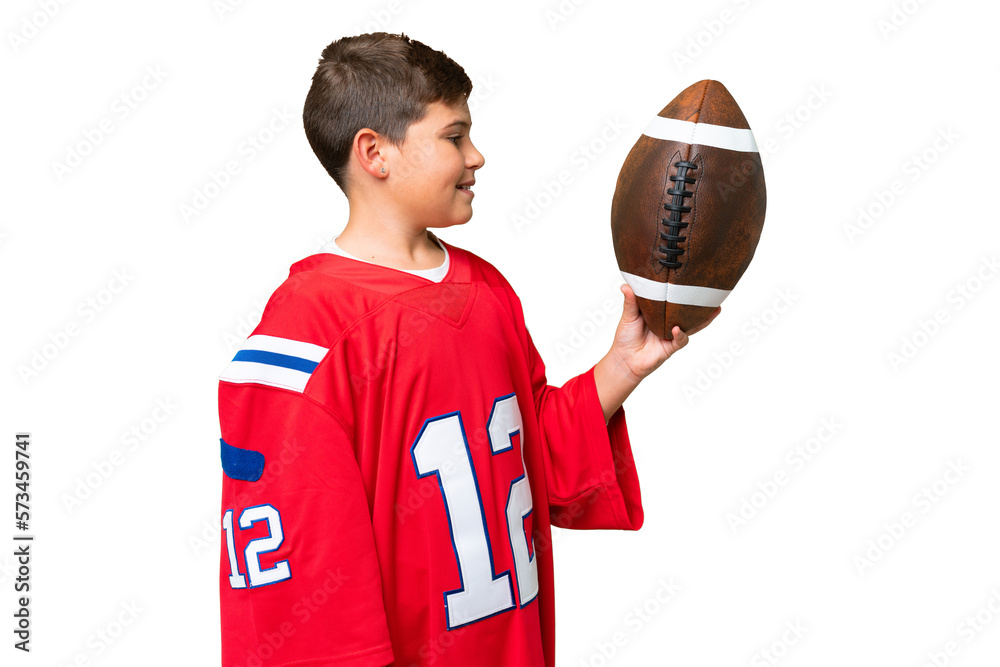 Little caucasian kid playing rugby over isolated chroma key background ...
