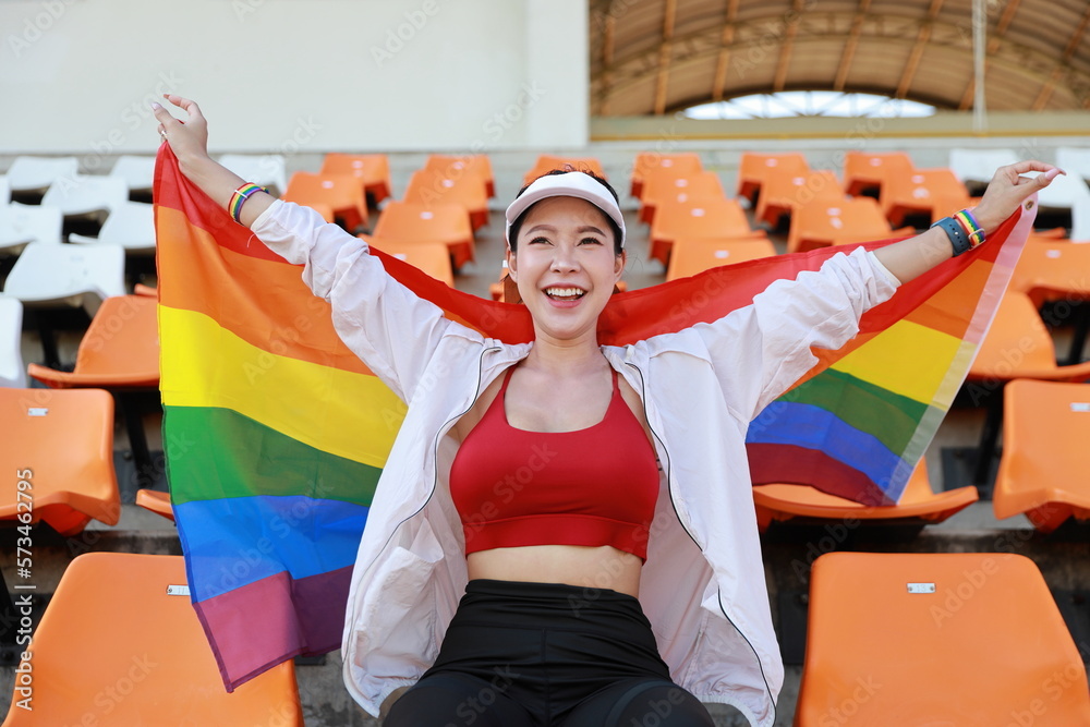 Happy and excited young female asian transgender LGBT sport fan ...