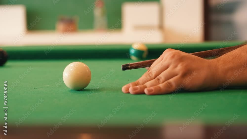 Playing pool billiards hitting the white cue ball in slow motion close ...