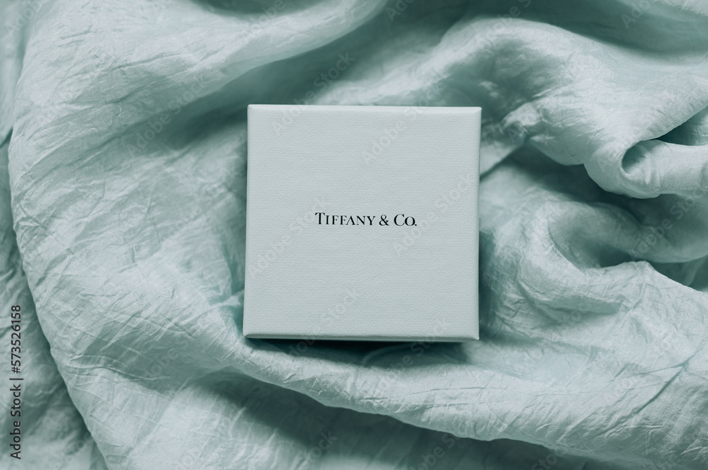 Tiffany box on a background of the folds of a turquoise silk scarf ...