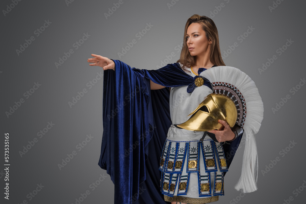 Studio shot of antique greek warrior woman dressed in blue cloak and ...