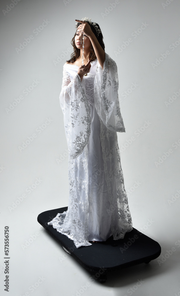 Full length portrait of beautiful woman wearing fantasy costume, white ...