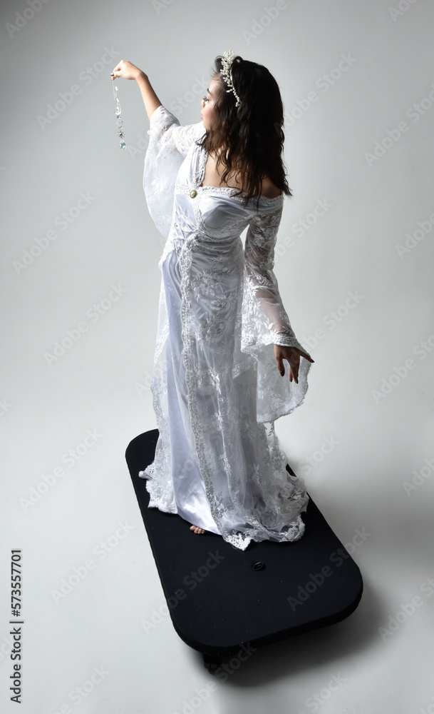 Full length portrait of beautiful woman wearing fantasy costume, white ...