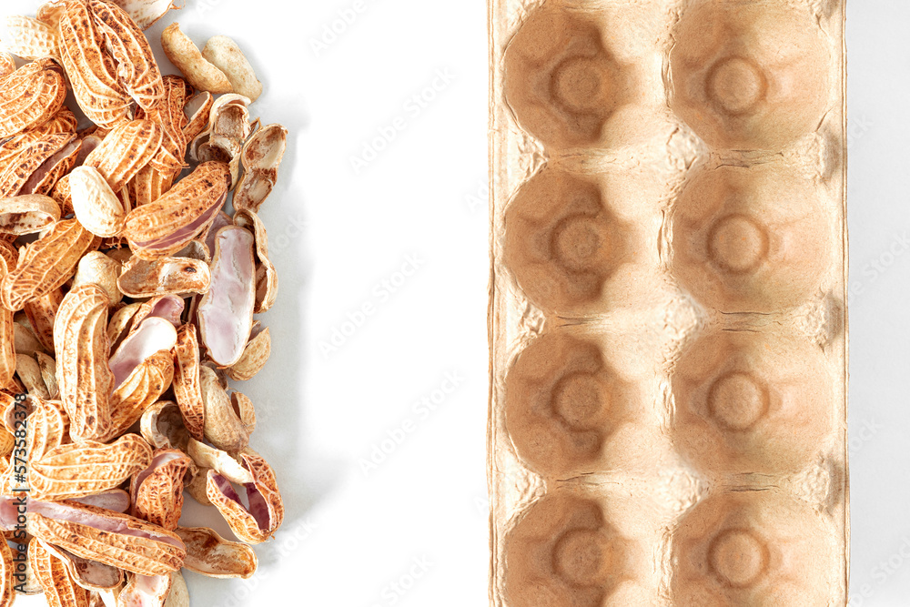Top view and close up on white floor. Husk of peanuts with empty egg ...