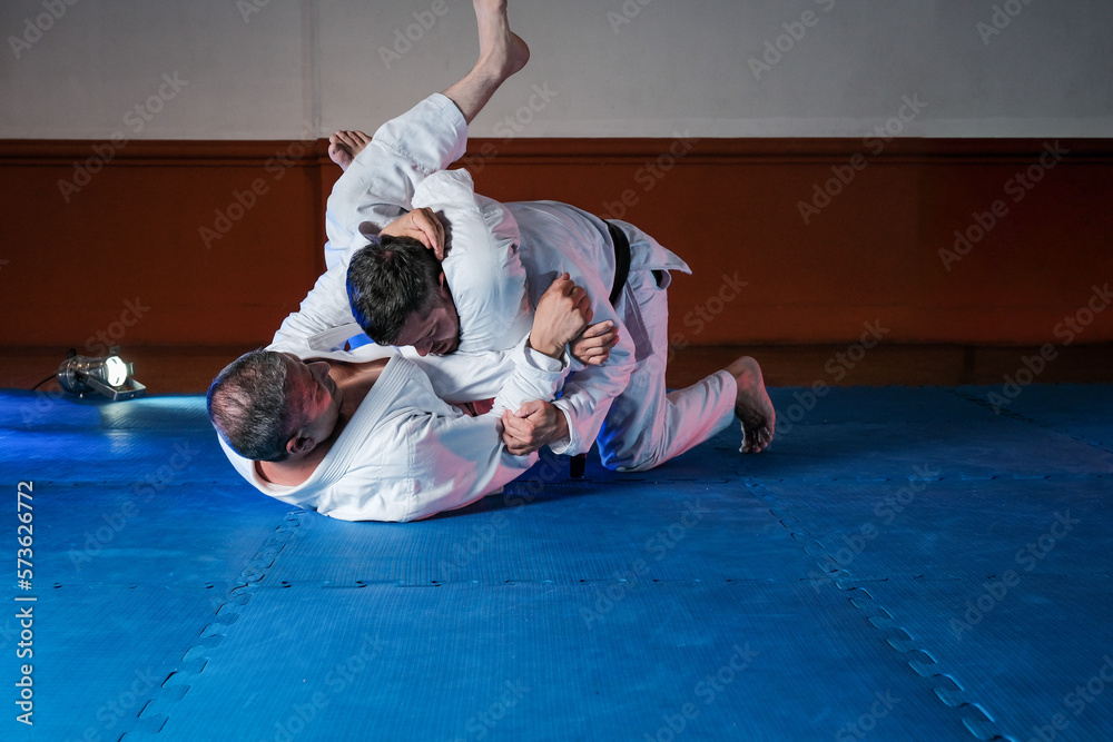 Foto de Two latin men training martial arts with kimonos, one black ...