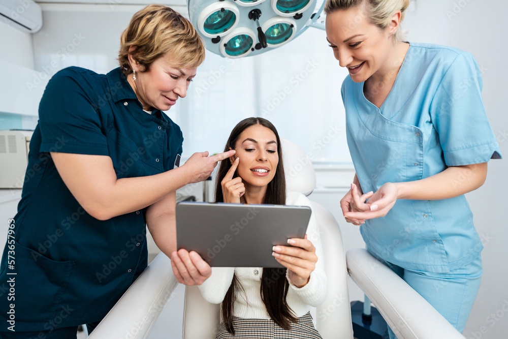 Beautiful and happy brunette woman at beauty medical clinic. She is ...