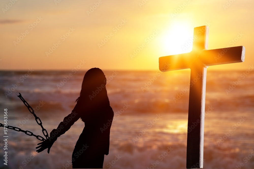 Silhouette of woman break chains with Holy Cross on background Stock ...