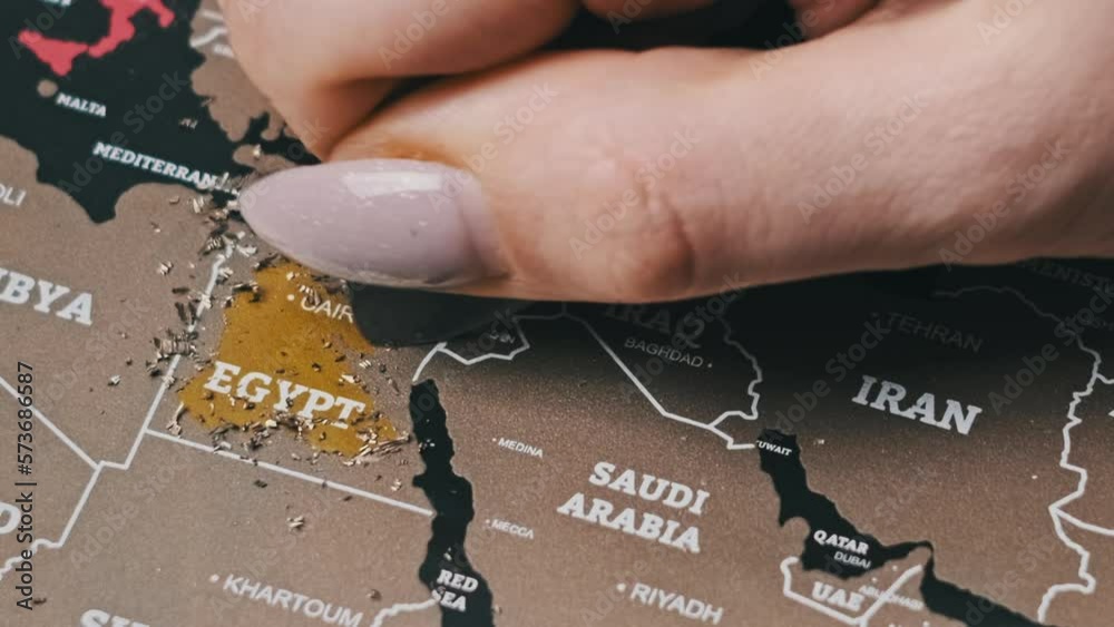 Scratching Egypt Country on the Surface of Scratch World Map. Woman ...