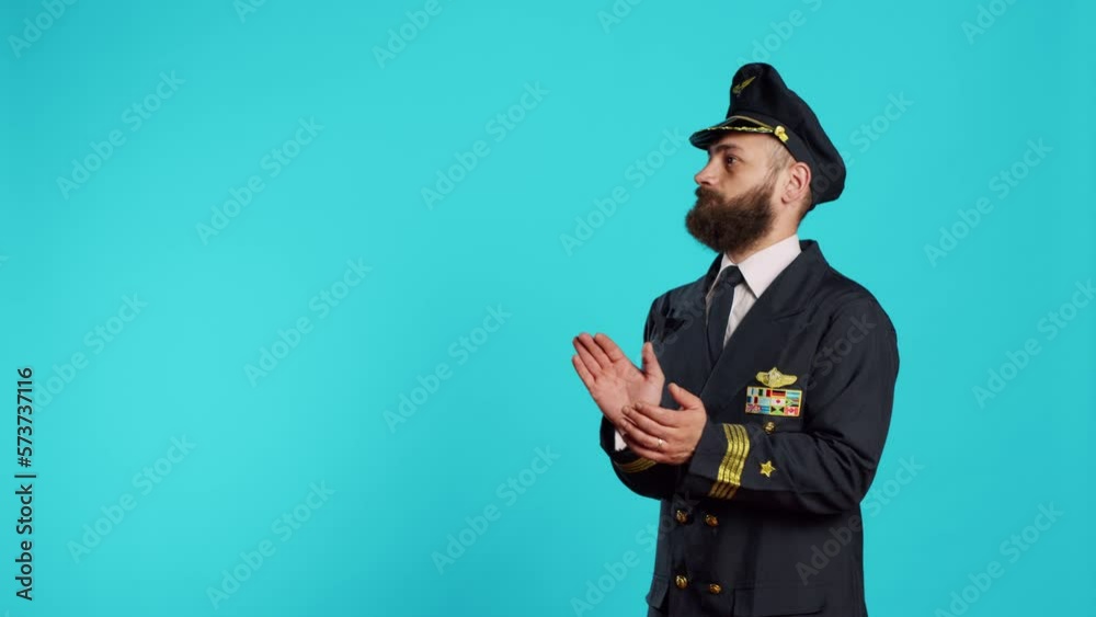 Male aviator applauding and cheering on camera, saying congratulations ...