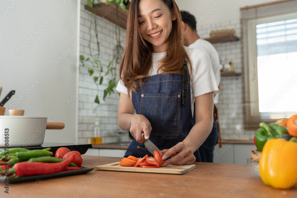 Beautiful Asian woman in kitchen cooking apron preparing various ...