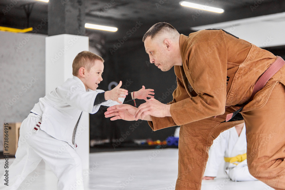 Dynamic portrait of man, professional judo, jiu-jitsu coach training ...