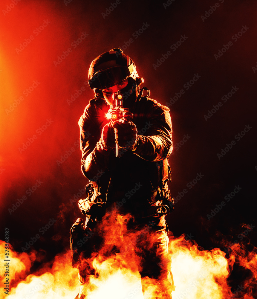 A silhouette of a soldier in fire and smoke, danger and intensity of ...