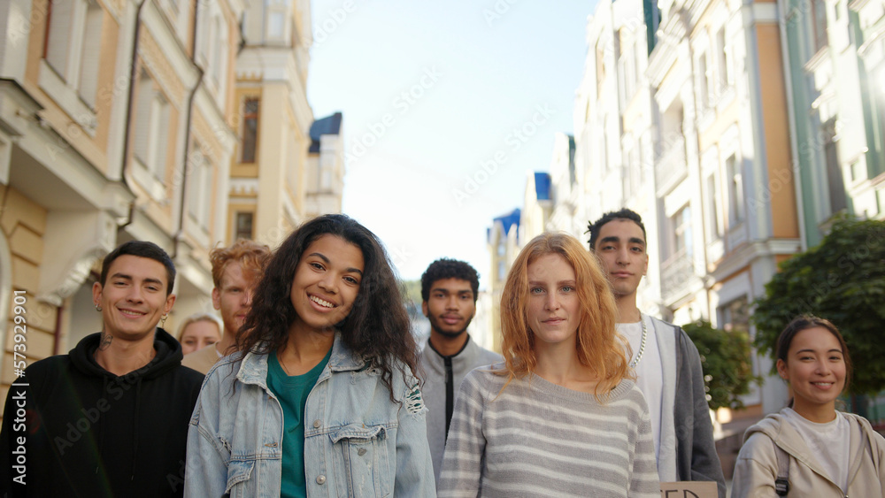 Two multiracial women holding hands together and lift them up in mass ...