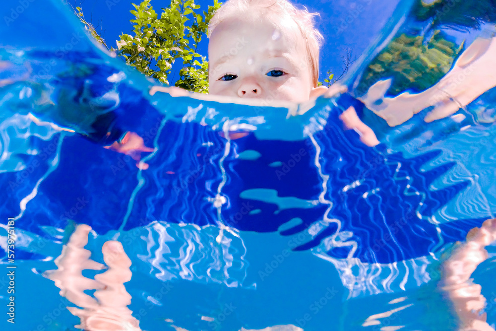 Cute baby swims underwater. Fun with water. Little girl is playing in ...