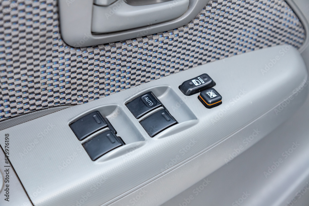 Close-up of the side door buttons: window adjustment buttons, door lock ...