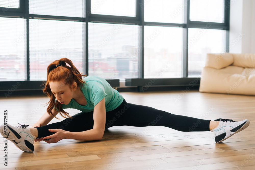 Front view of sporty young woman doing therapeutic exercises for ...