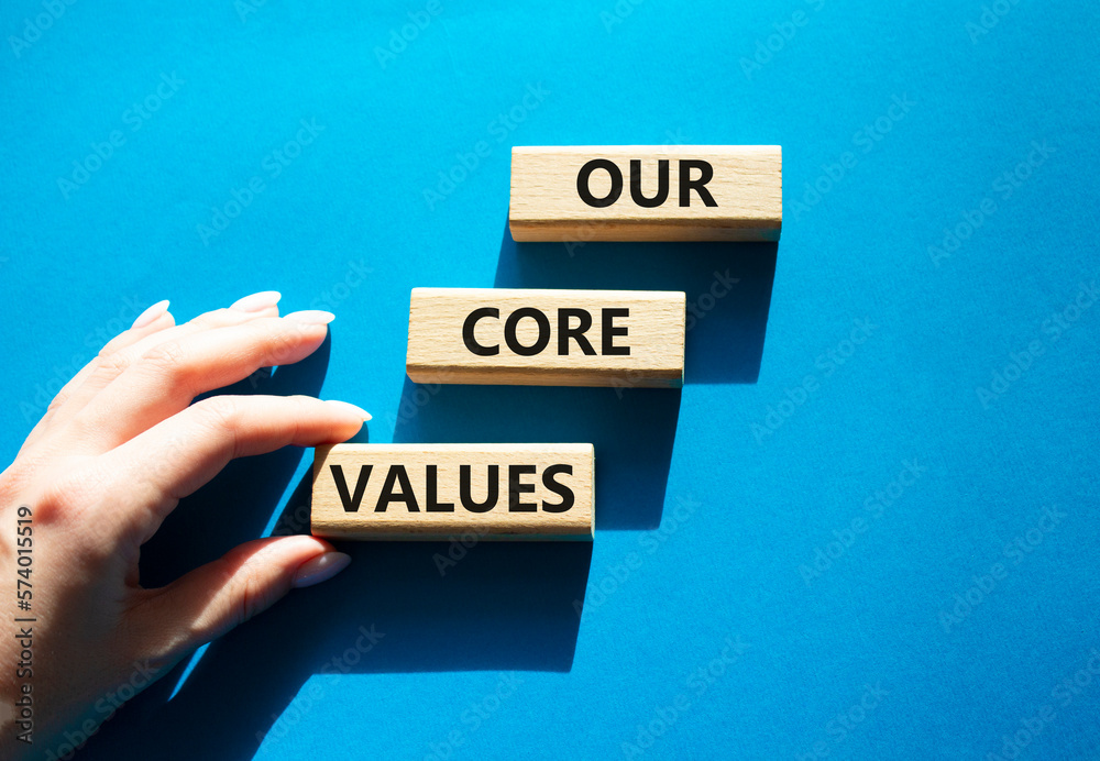 Our core values symbol. Concept words 'Our core values' on wooden blocks. Beautiful blue ...