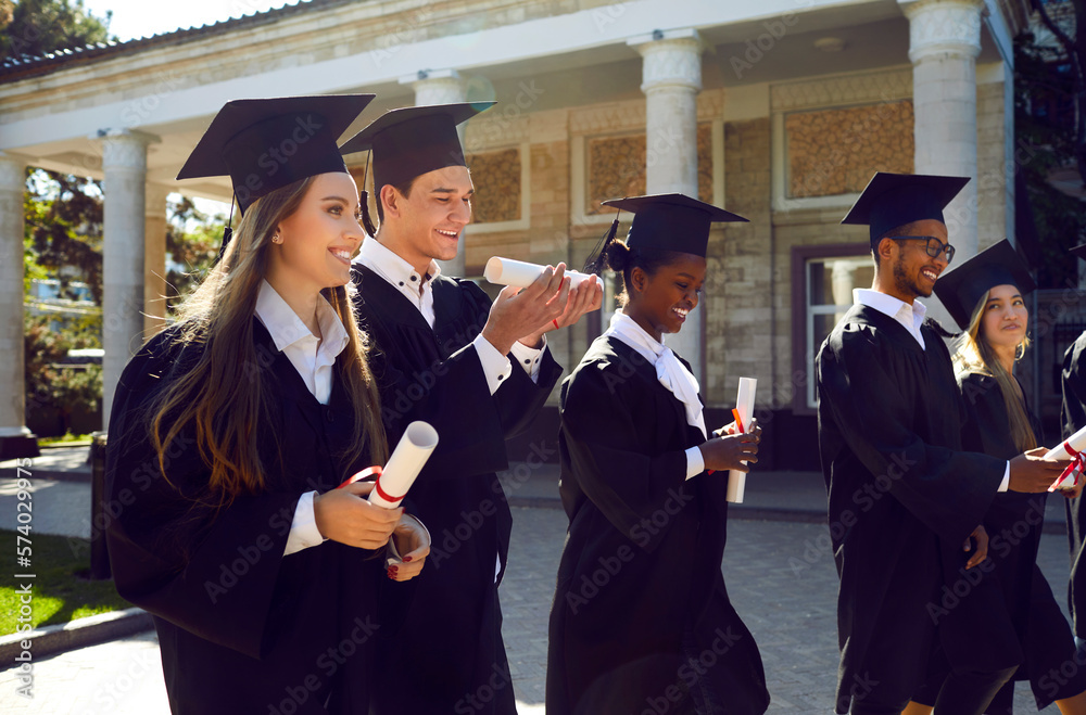 Poster Institute graduates in festive uniforms, in square hats and ...