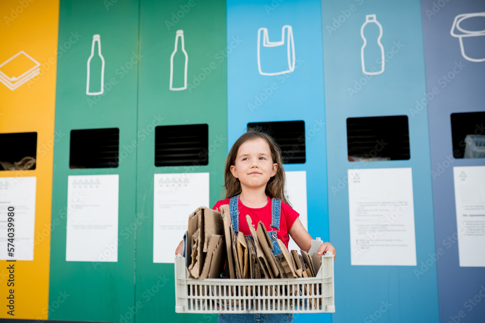 Portrait of cute girl holding box with cardboard for reduce, reuse ...