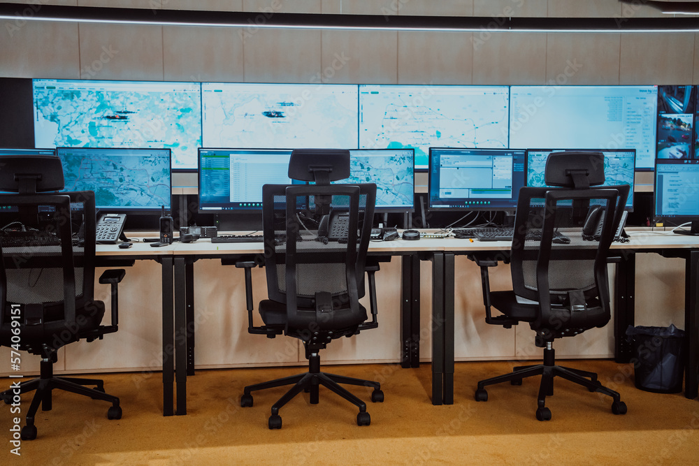 Empty interior of big modern security system control room, workstation ...