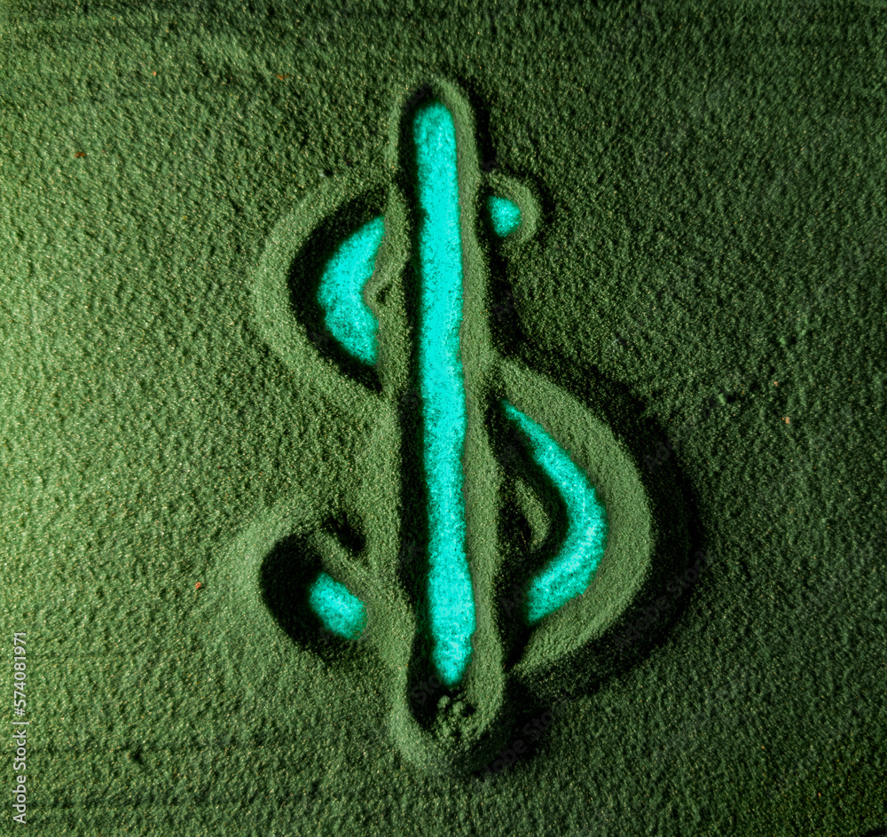 Hand Drawing The Dollar Currency Symbol In The Green Sand Male Hand hand-drawing-the-dollar-currency-symbol-in-the-green-sand-male-hand