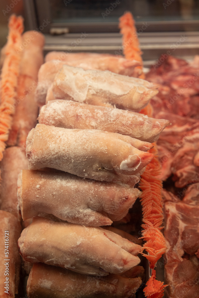 Frozen pig feet and beef on display in a glass freezer at the Municipal ...