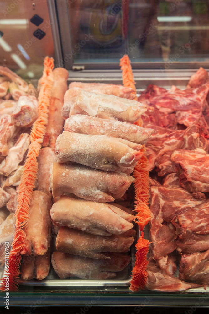 Frozen pig feet and beef on display in a glass freezer at the Municipal ...
