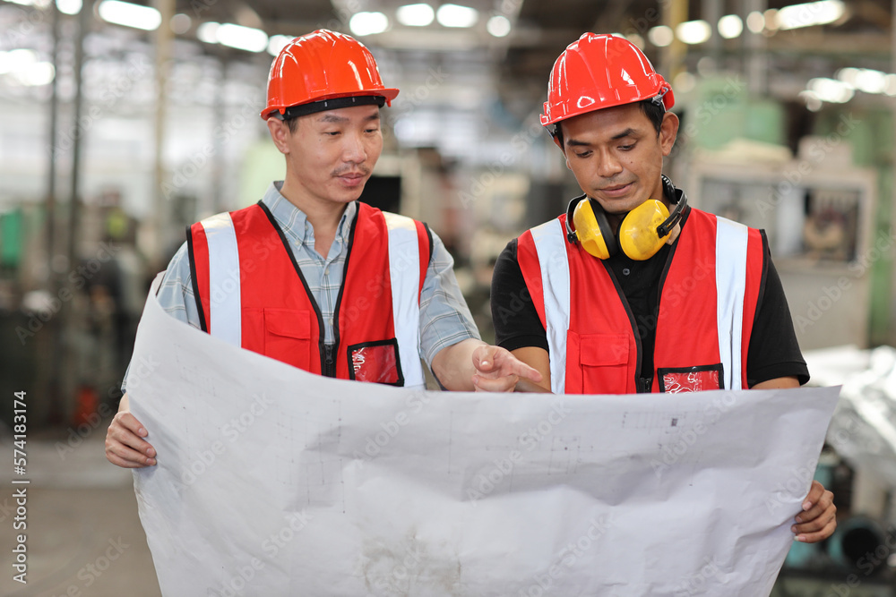 Architect men and worker standing and checking at heavy industry ...
