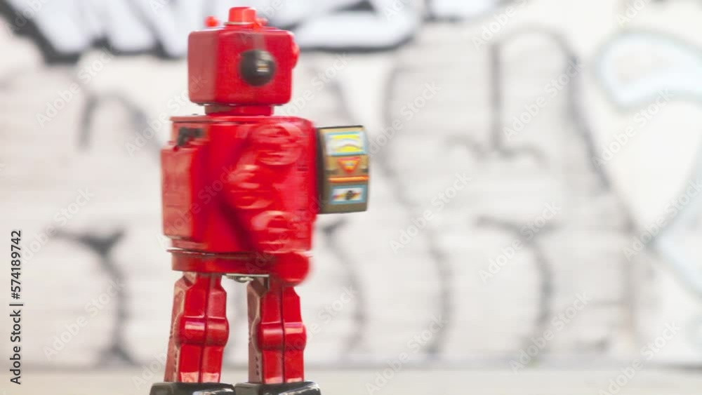 Bright red Robot marching in a loop with a futuristic laser gun ...