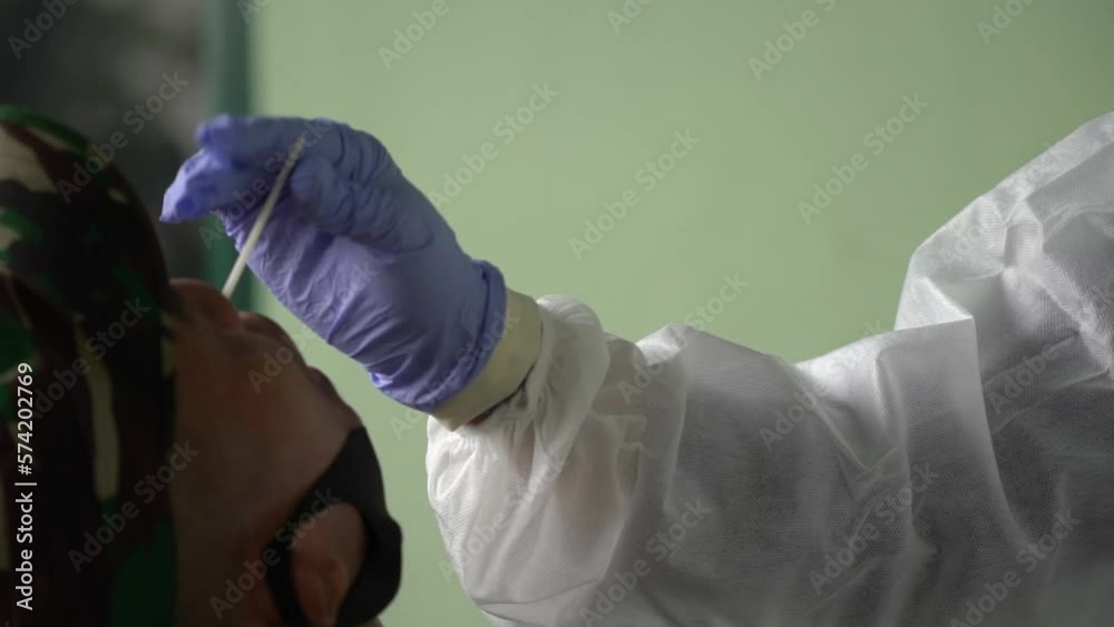 The medical staff took a mucus sample to be examined as a swab test ...