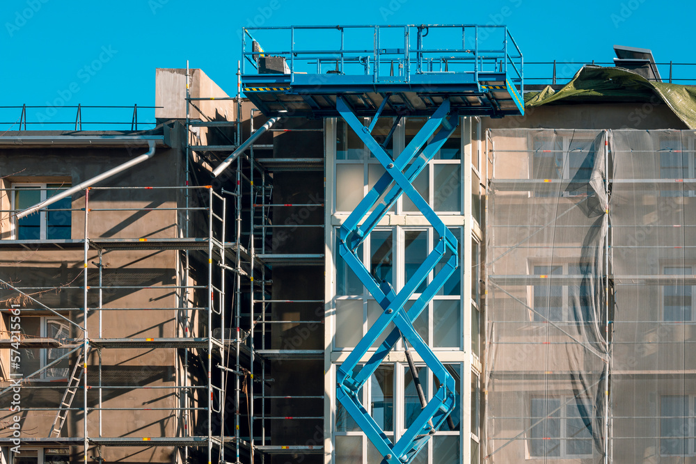 Old multistory facade repair using a high scissor lift with a platform ...